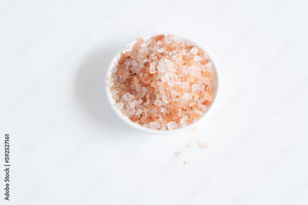 Himalayan pink salt (rock salt, halite mined) in white bowl isolated on ...