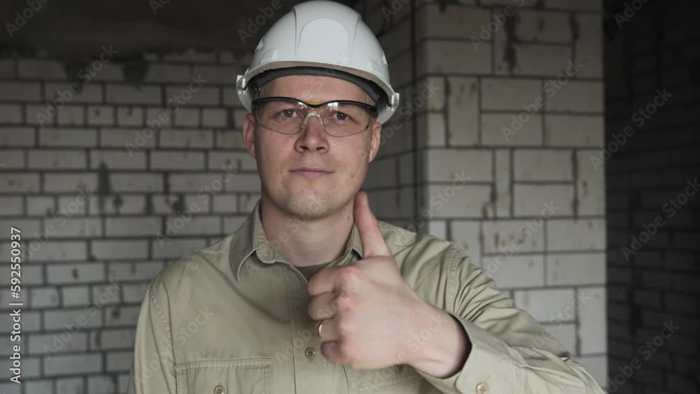 A professional builder confident in his work looks into the camera and ...