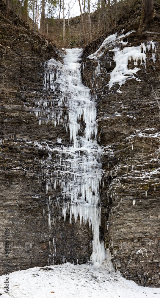 Water seeping out of a rock wall forms natural icicles along the gorge ...