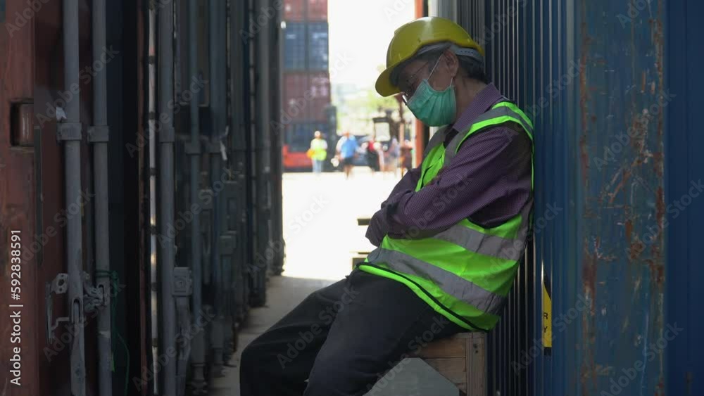 asian old man container worker sleep at work in outdoors warehouse ...