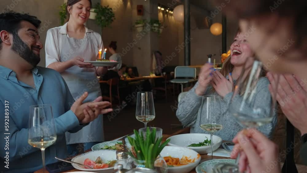 Waitress brings birthday surprised woman cake to celebrate with friends ...