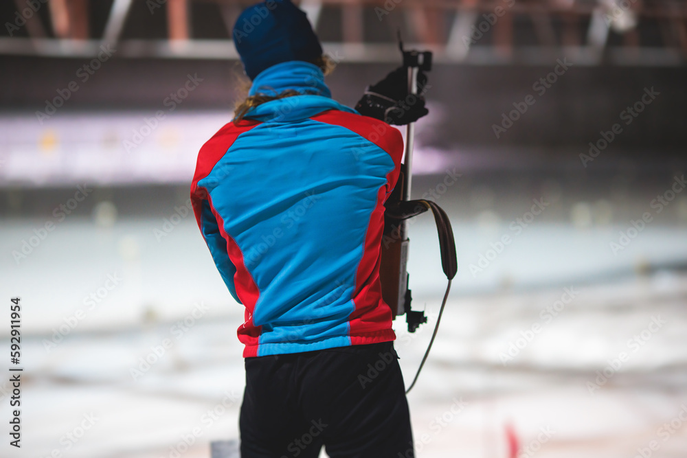 Biathlete with rifle on a shooting range during biathlon training ...