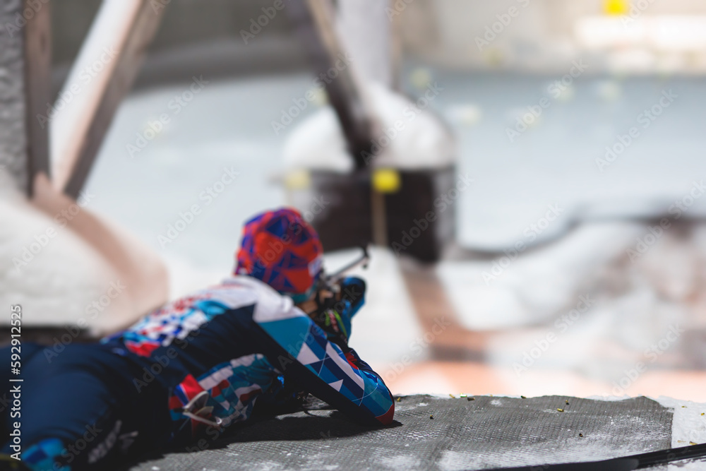Biathlete with rifle on a shooting range during biathlon training ...