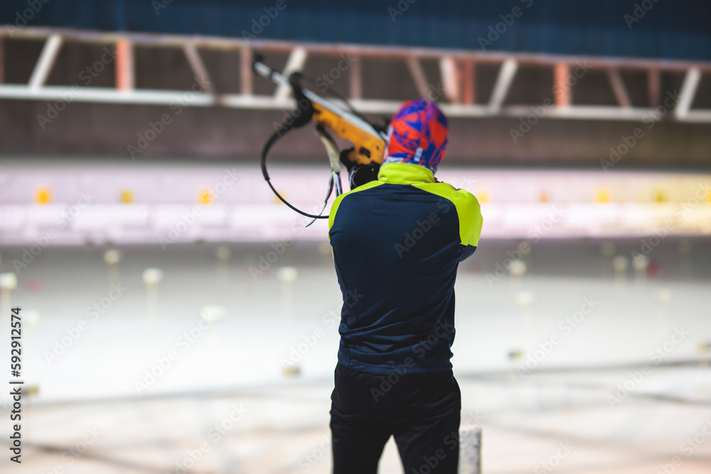 Biathlete with rifle on a shooting range during biathlon training ...