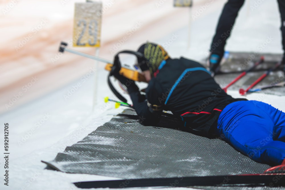 Biathlete with rifle on a shooting range during biathlon training ...