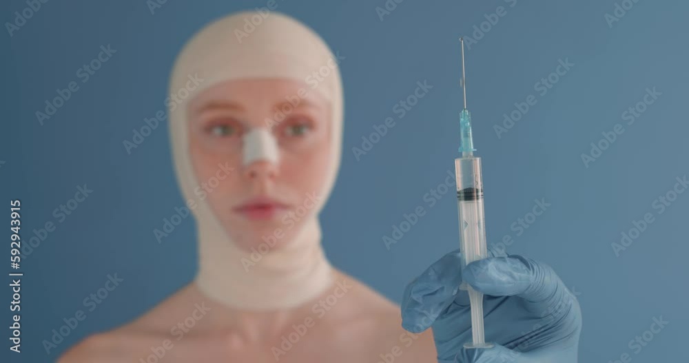 serious beautiful woman in medical bandages and plaster over nose ...