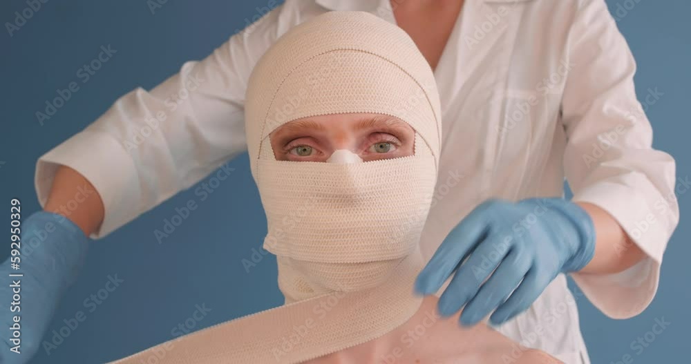Cropped doctor's arms taking off bandage from female week pale patient ...