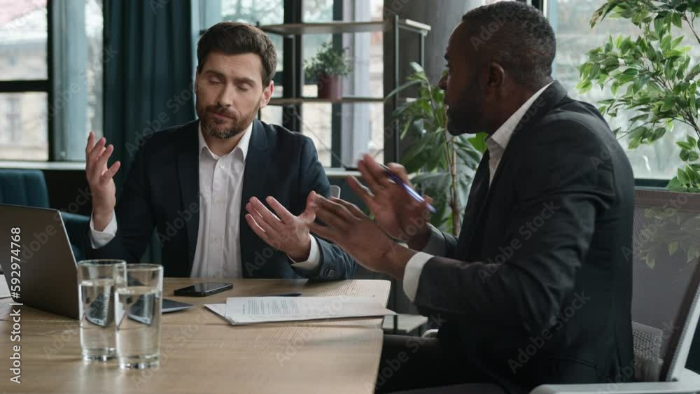 Two dissatisfied diverse businessmen arguing in office meeting business ...