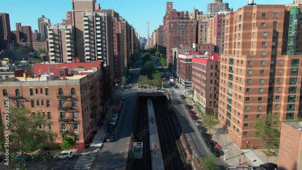 Trains entering and leaving subway tunnel NYC Park Ave rising drone ...
