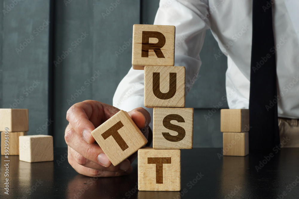 Build trust concept is shown using the text. Hand stacking wooden ...