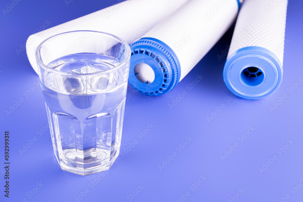 set three of cartridges for water filter with clear glass of water ...
