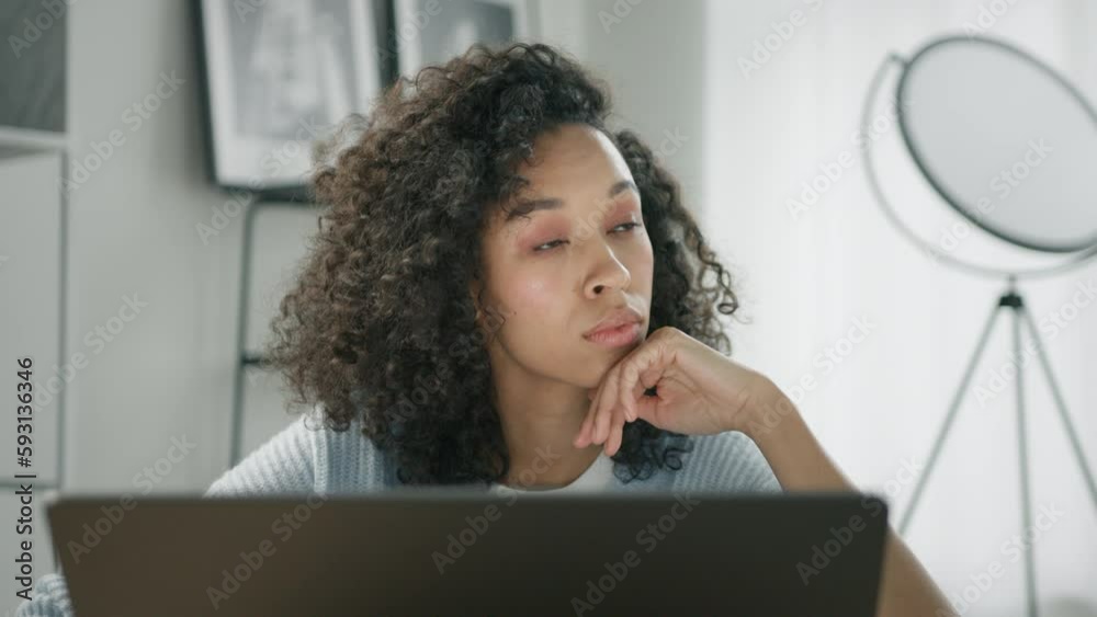 Sad African business woman finishing computer work and closing laptop ...
