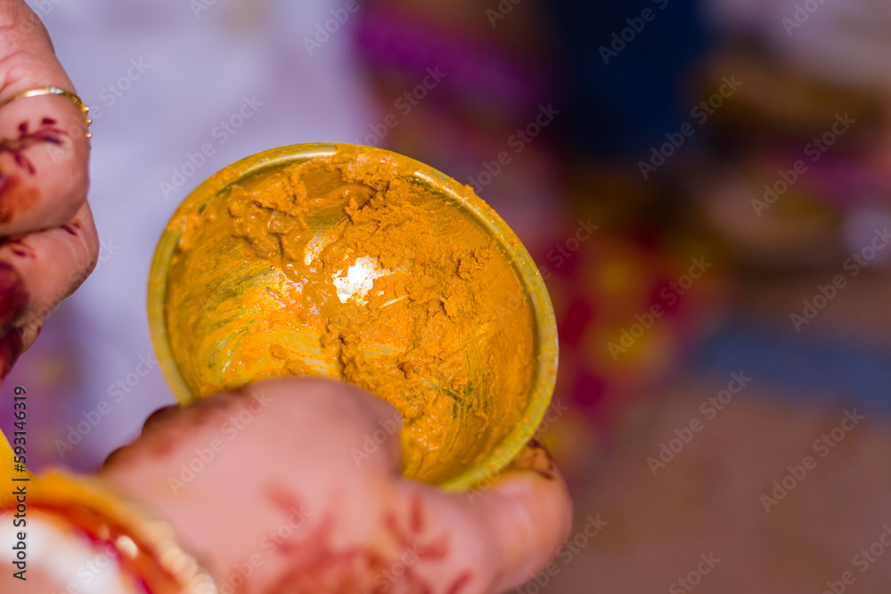 Turmeric paste in a brass bowl for Gaye holud ritual of Hindu marriage ...