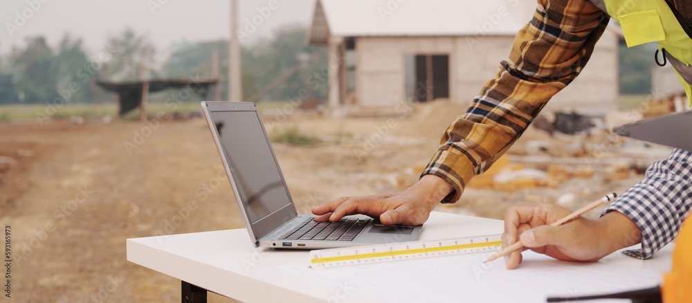 Team of engineer and worker checking construction site outdoors ...