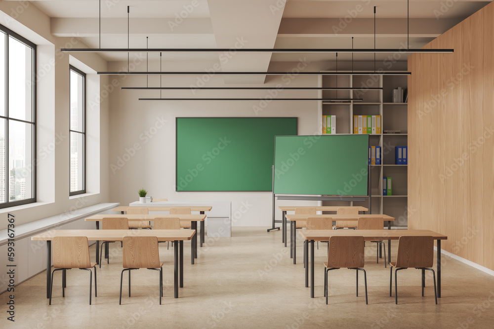 Stylish beige classroom interior with desk in row and chalkboard mockup ...