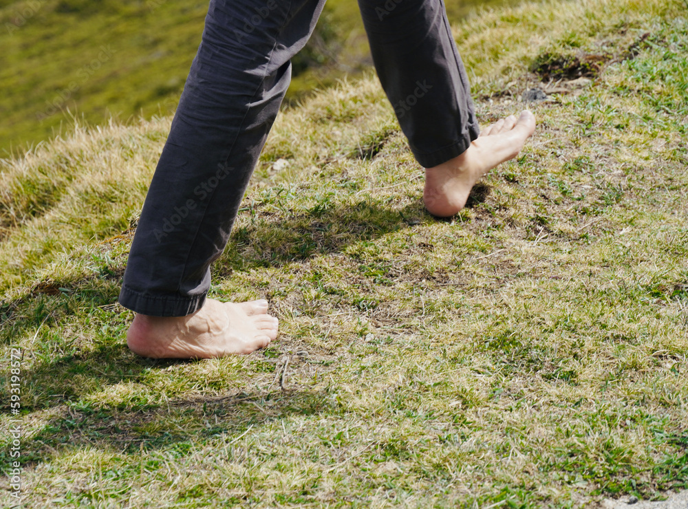 Bare feet in the green grass. Health benefits. Concept of earthing ...