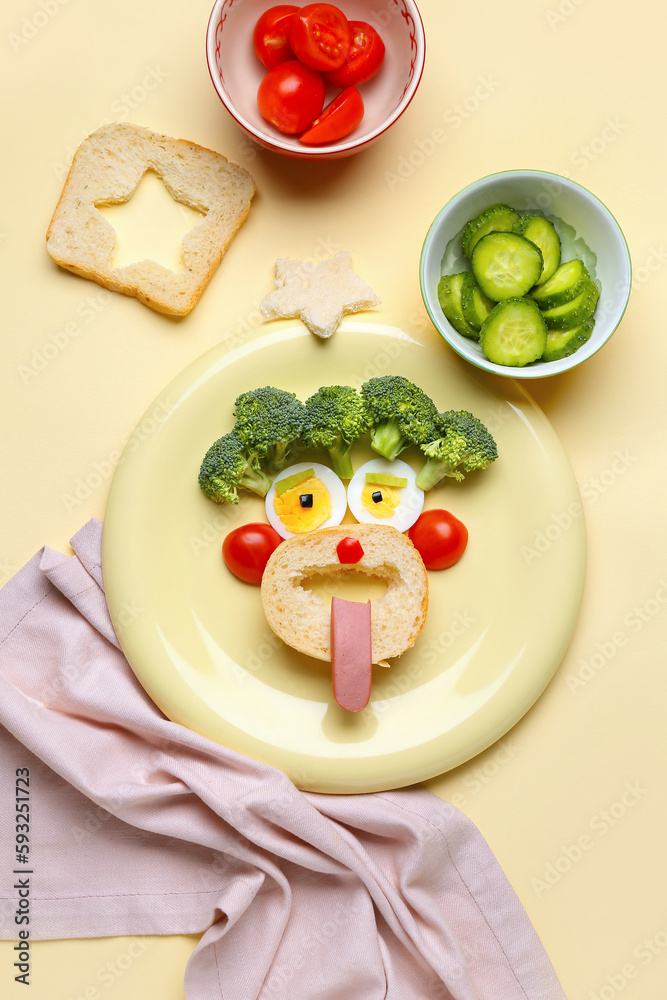 Plate with funny breakfast in shape of face and vegetables on beige ...