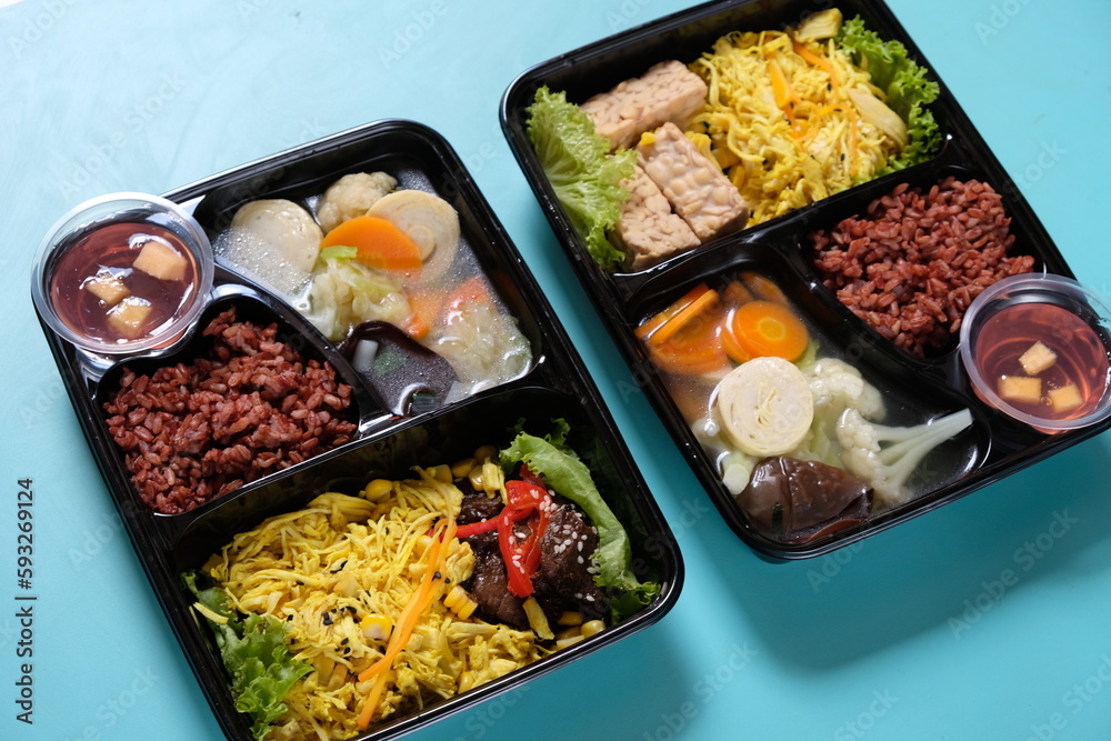 healthy food bento with brown rice, yellow shredded chicken, vegetable ...