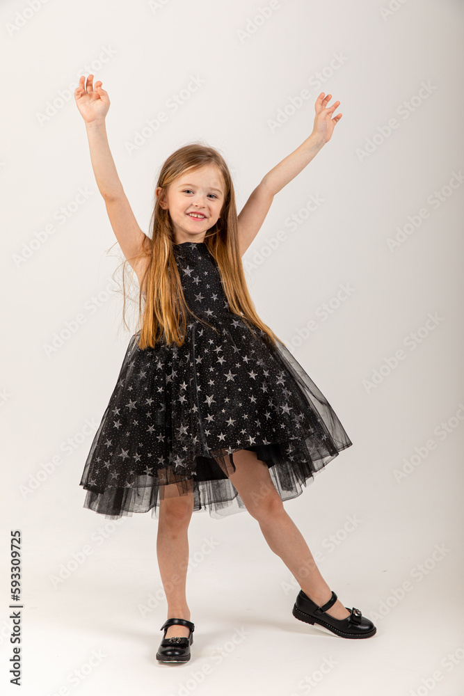 Portrait of cute smiling little girl in black princess fluffy dress ...