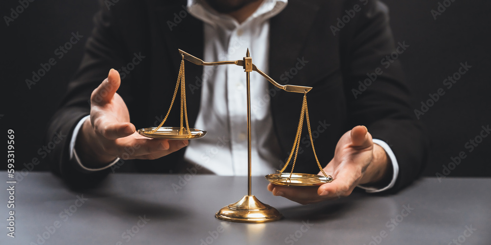 Lawyer or judge in formal black suit hold unbalanced scale with ...