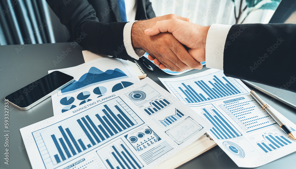 Closeup professional businessman shaking hands over desk in modern ...