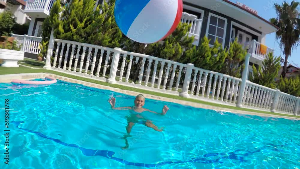 Play with a ball in the pool. A family have a funny time together with ...