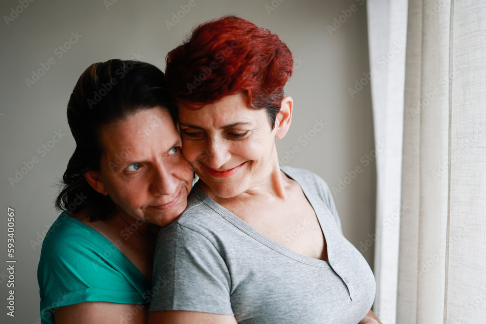 Gay Senior Lesbian Couple Hugging Indoor At Home Diversity Lgbtq