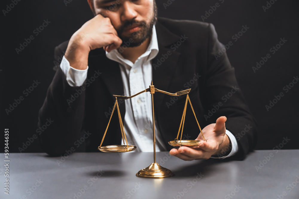Lawyer or judge in formal black suit hold unbalanced scale with ...