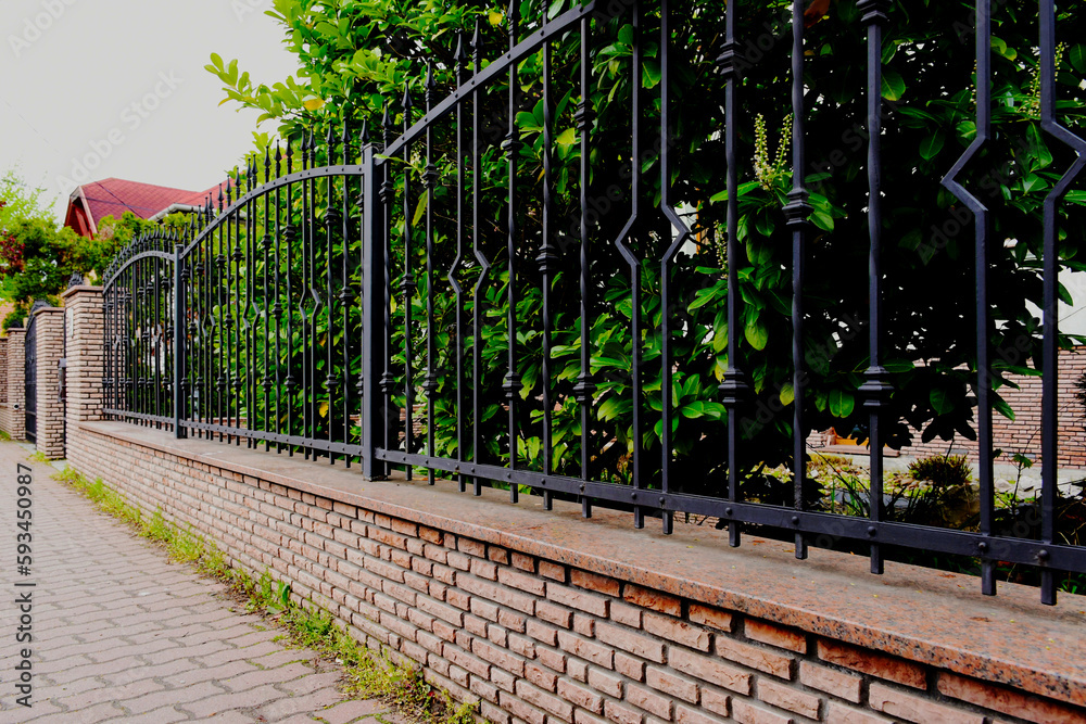decorative wrought iron picket fence panels between stucco finished ...