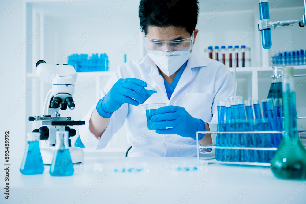 Scientist mixing chemical liquids in the chemistry lab. Researcher ...
