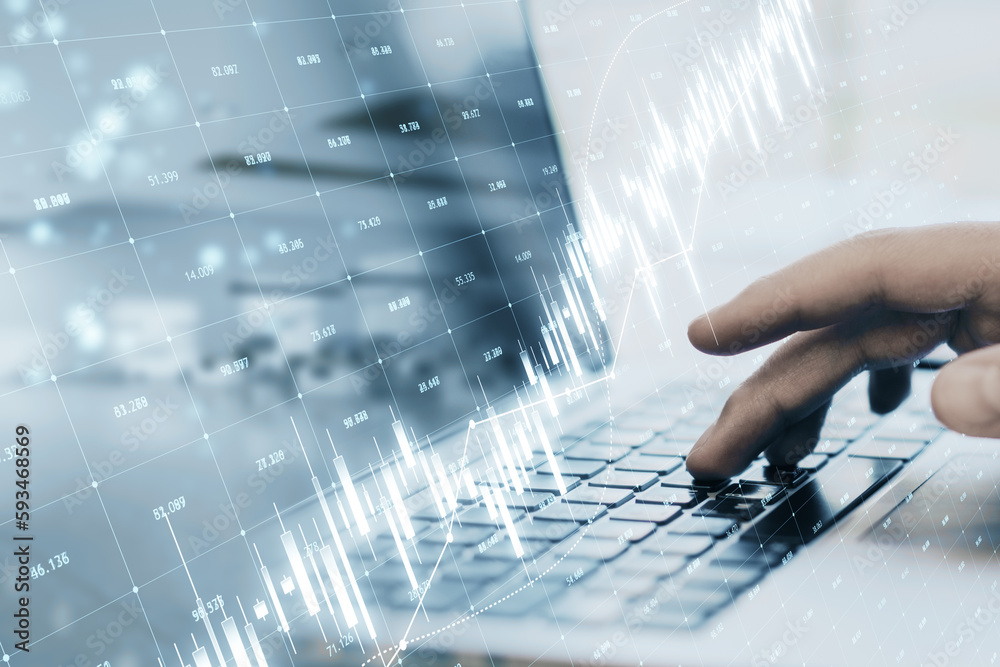 Close up of hands using laptop keyboard with glowing candlestick forex ...
