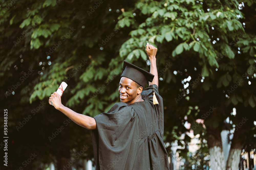 Portrait back view of happy black man graduate from university stand ...