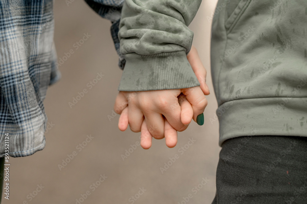 Teenage brother and sister holding hands on rainy day Stock Photo ...