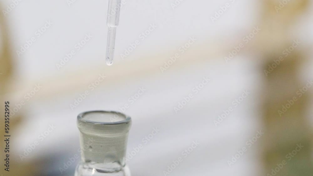 Scientist Carefully Drips Water into Test Tube in Slow Motion using an ...