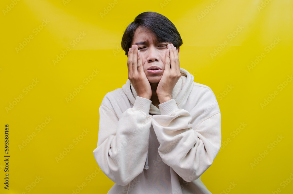Sad A young Asian man wearing a gray t-shirt with a crying face ...