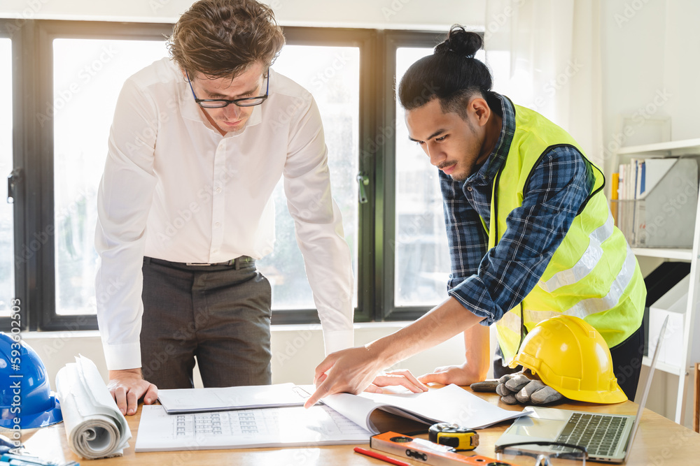architect explaining client demand plan of construction on the table to ...