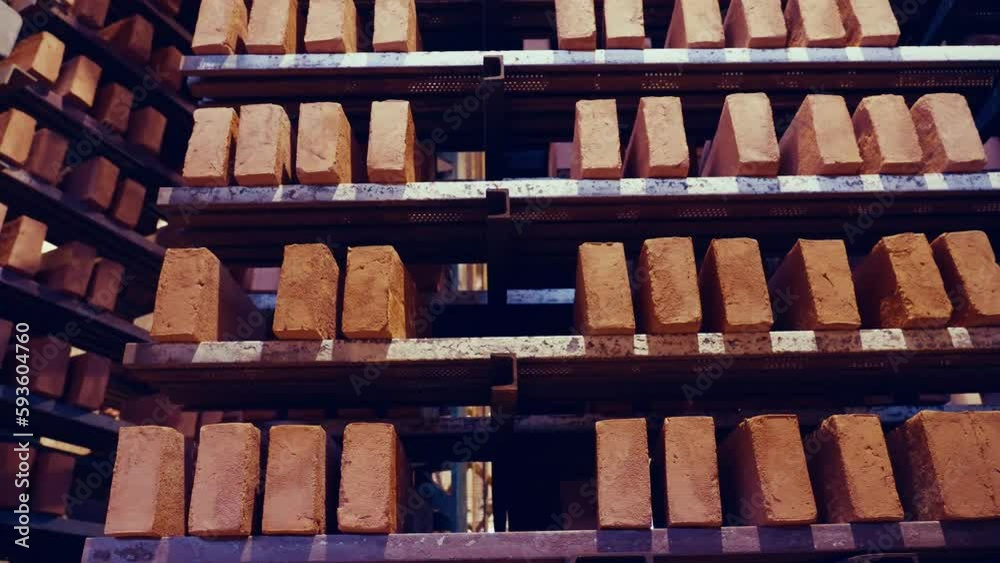 Rotating shelves of red oldschool bricks. Dried bricks from the kiln ...