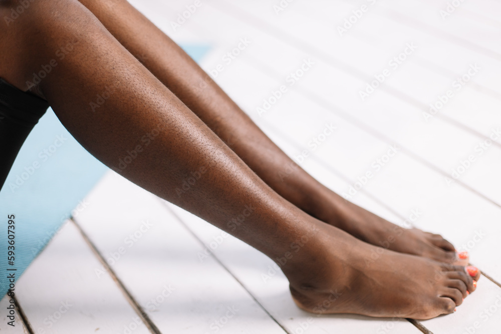Bare legs of afro american woman closeup, white floor background free ...