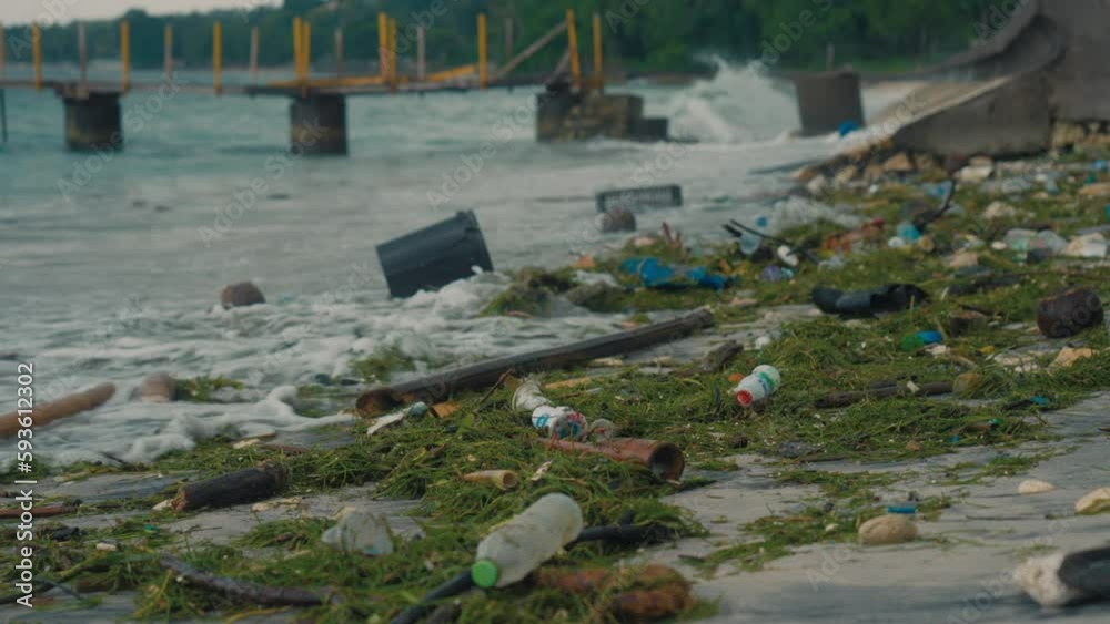 The waves of the ocean throw out plastic baskets and other garbage ...