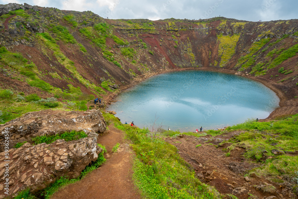 Top view of Kerid Crater Lake in Iceland on a cloudy day with people ...