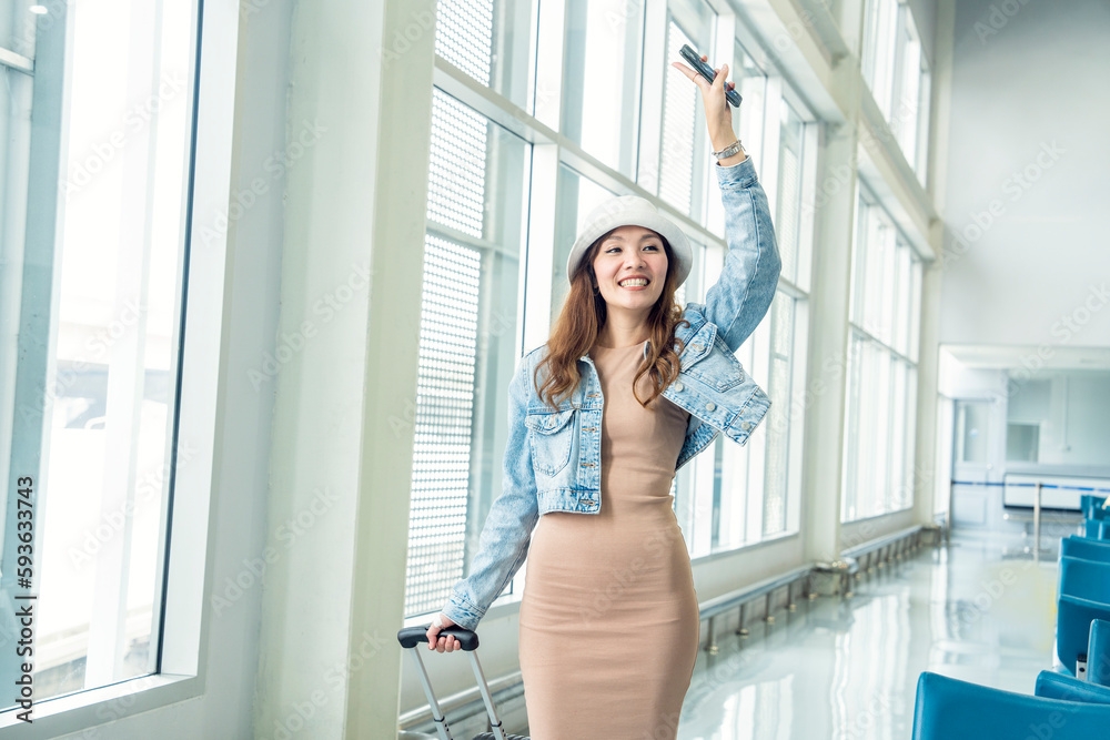 Asian female tourist backpacking in denim jacket dress dragging luggage ...