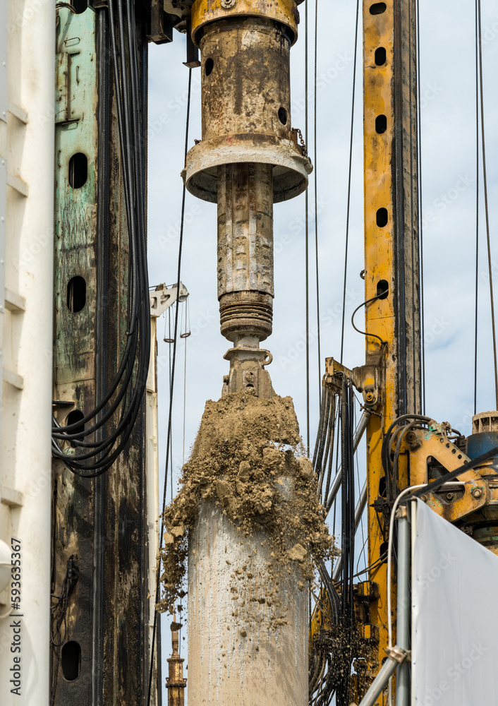 Foto de Dirt falling from auger or drill creating foundations for new ...