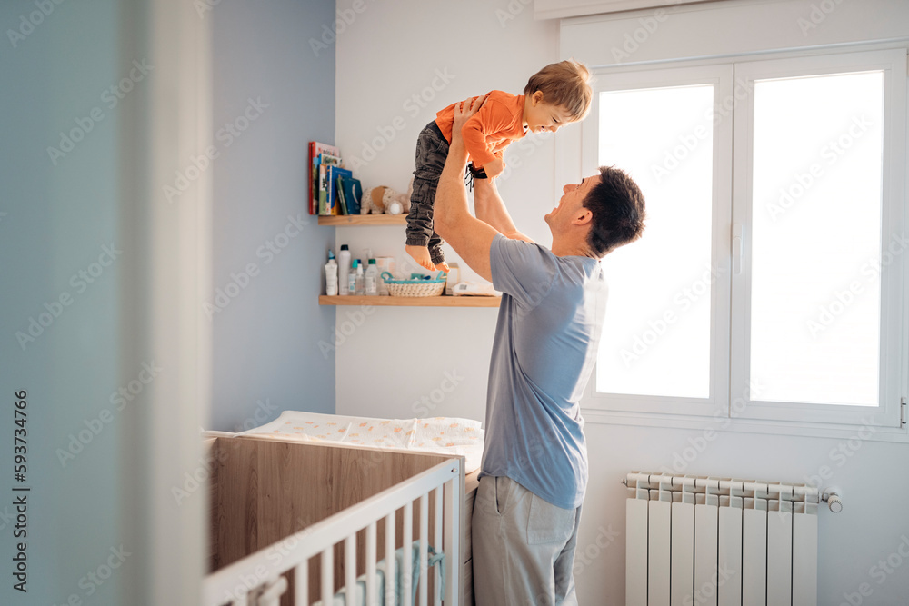 Father hugging a child next to a cradle Stock Photo | Adobe Stock