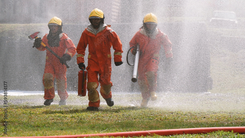 Firefighter Rescue team training in fire fighting extinguisher ...