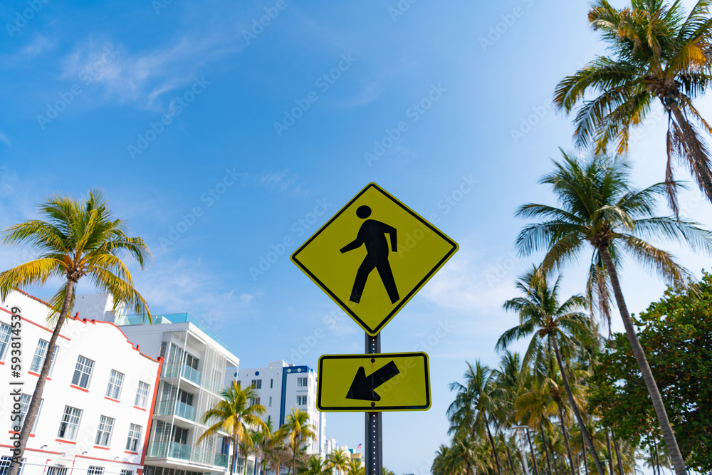 Yellow pedestrian crossing road traffic sign with pointing arrow plaque ...