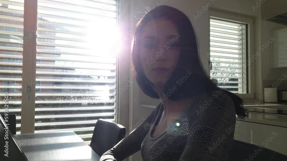 Lens flare, window, open-plan, working, laptop, young, long hair Stock ...
