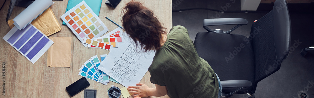 Top view of interior designer or architect in casual wear with messy ...