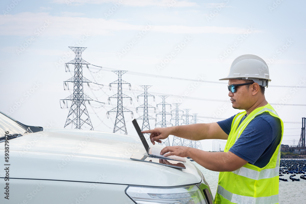 Electrical engineer inspecting high voltage transmission towers Stock Photo | Adobe Stock