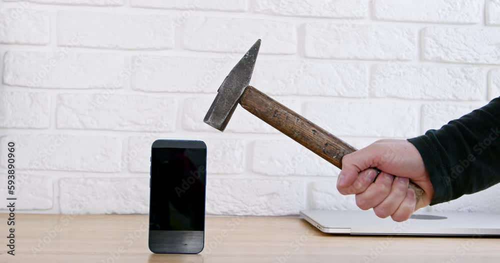 A person hits a smartphone with a hammer and does not break it, stops ...