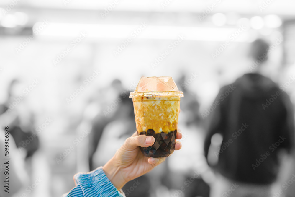 woman hand holding brown sugar boba milk tea with tapioca pearls at ...